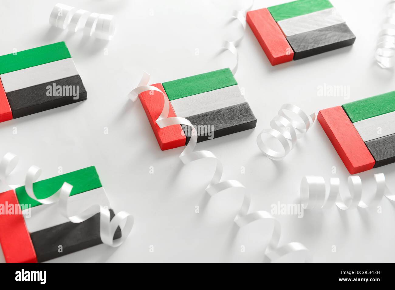 UAE flags made of blocks with ribbons on white background Stock Photo ...