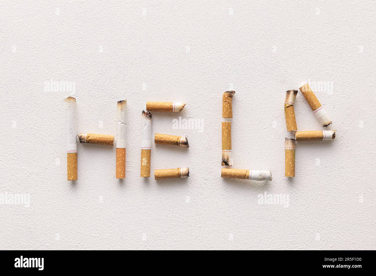Word HELP made of cigarette butts on light background. Stop smoking ...