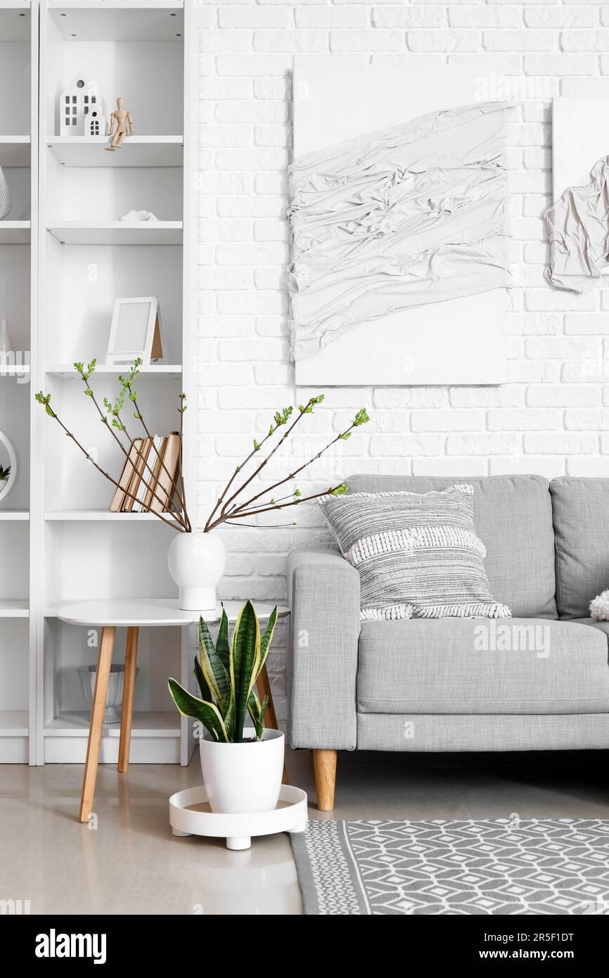 Stylish interior of modern living room with posters Stock Photo - Alamy