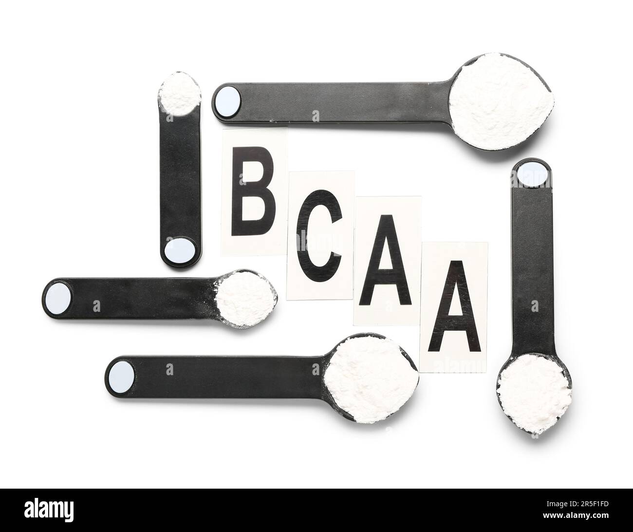 Letters BCAA and scoops of amino acid supplement on white background ...