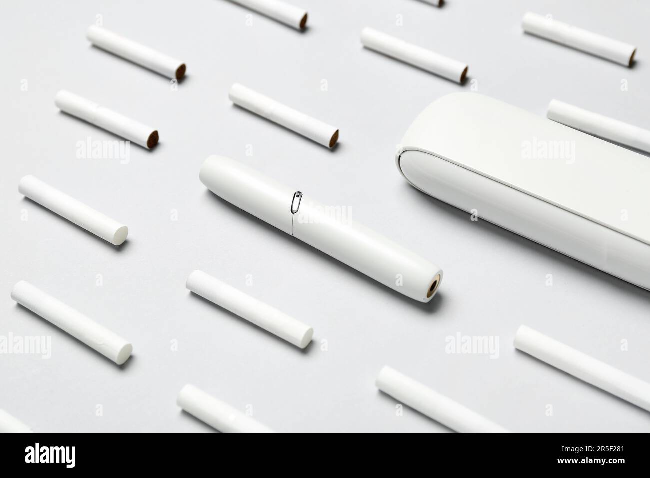 Modern electronic cigar and many sticks on grey background Stock Photo ...