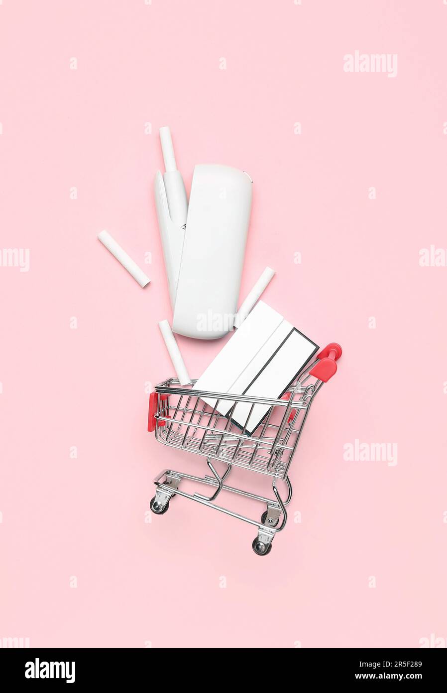 Composition with shopping cart, modern electronic cigar and pack of ...