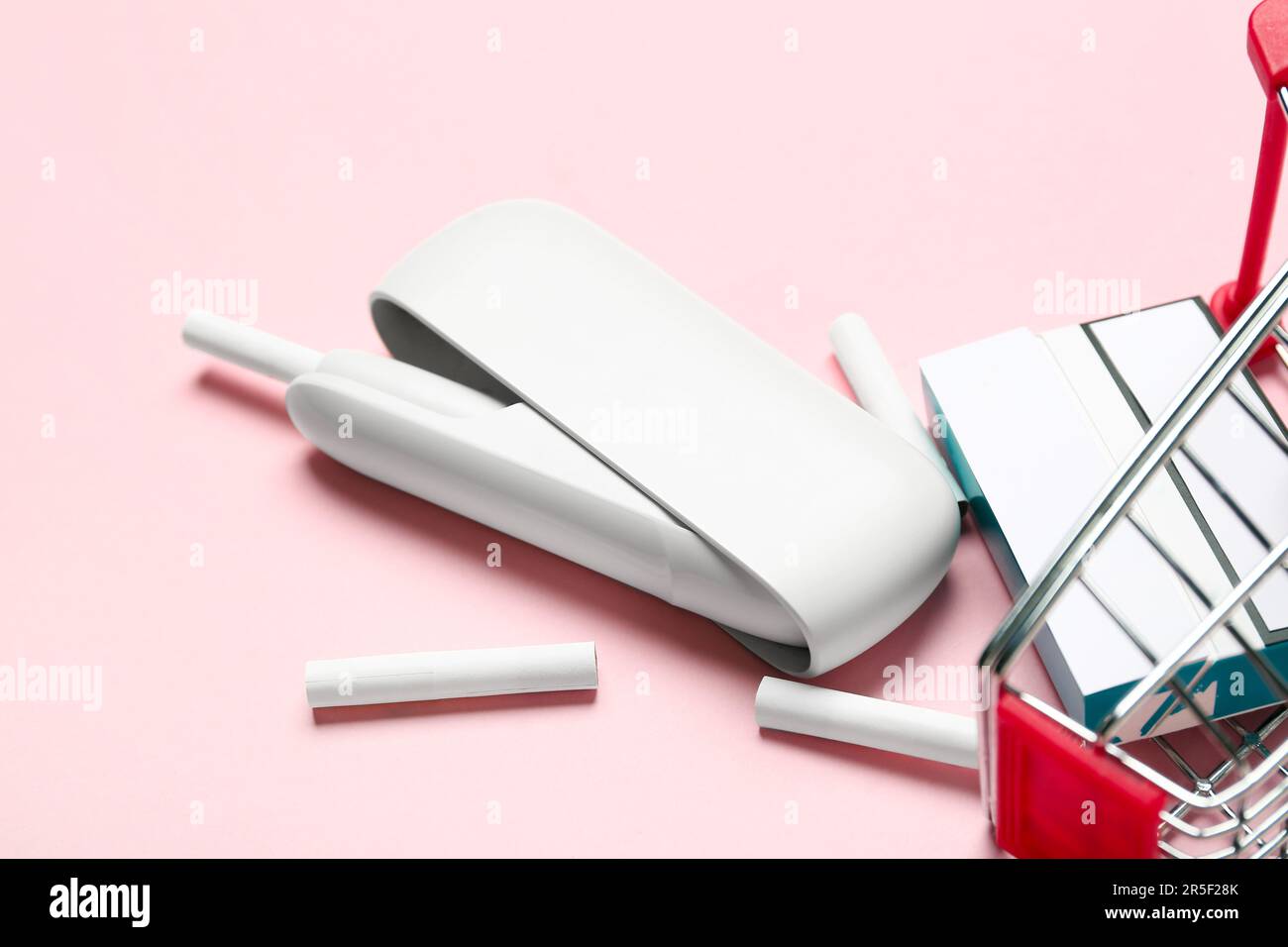 Composition with shopping cart, modern electronic cigar and pack of ...