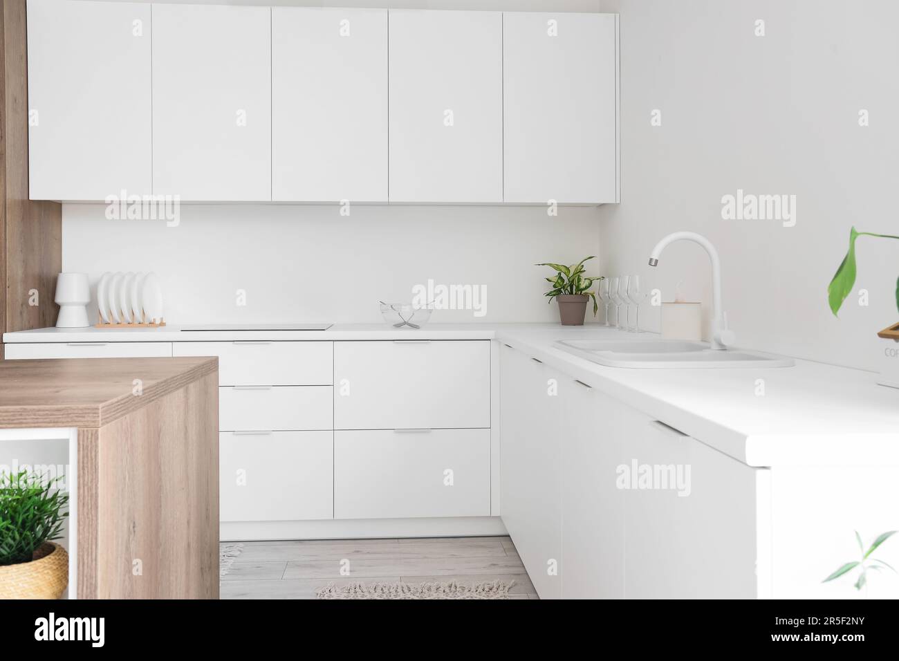 Interior of light kitchen with white counters Stock Photo - Alamy