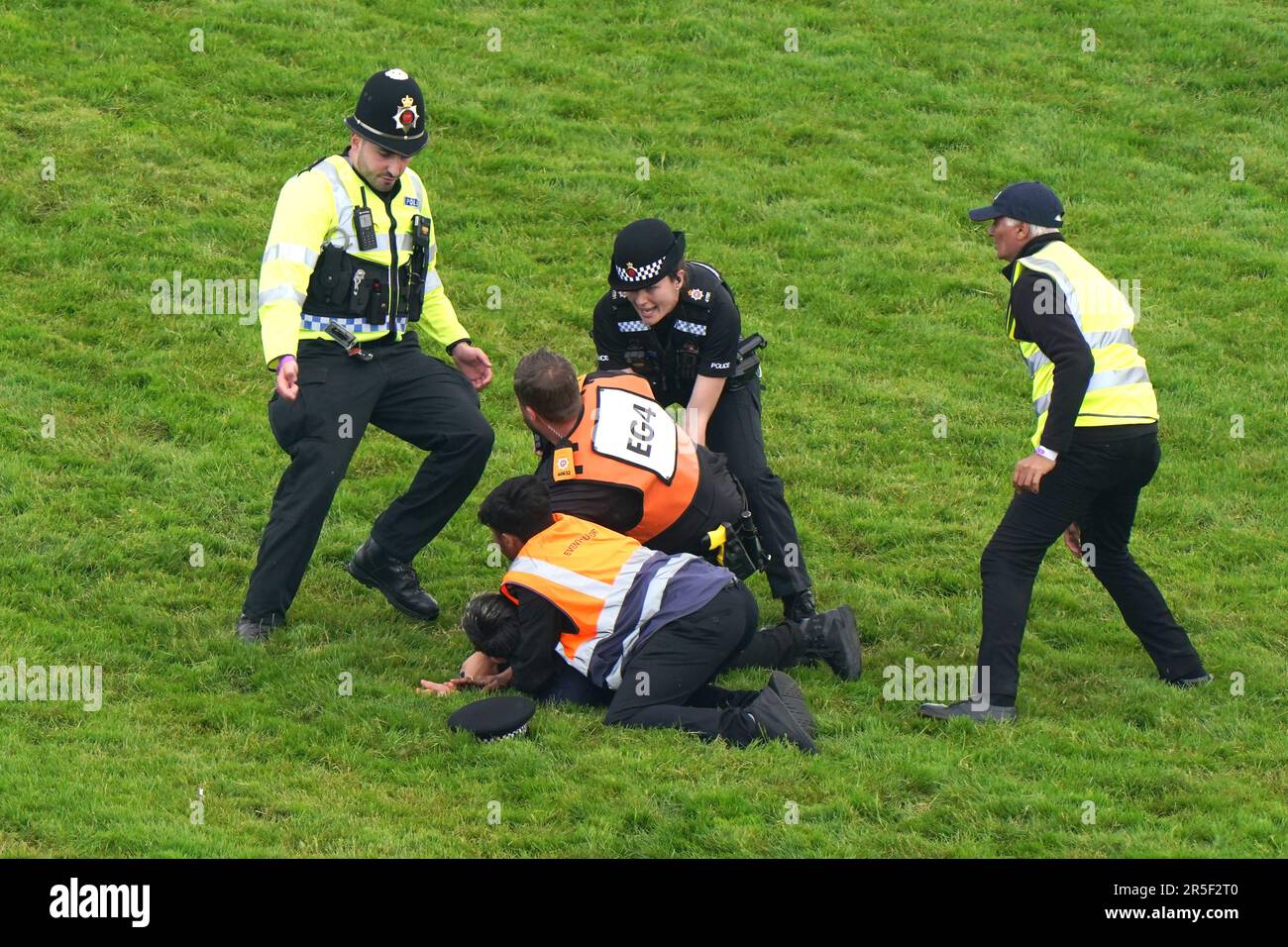 A protestor is escorted off the track by police and stewards during the ...