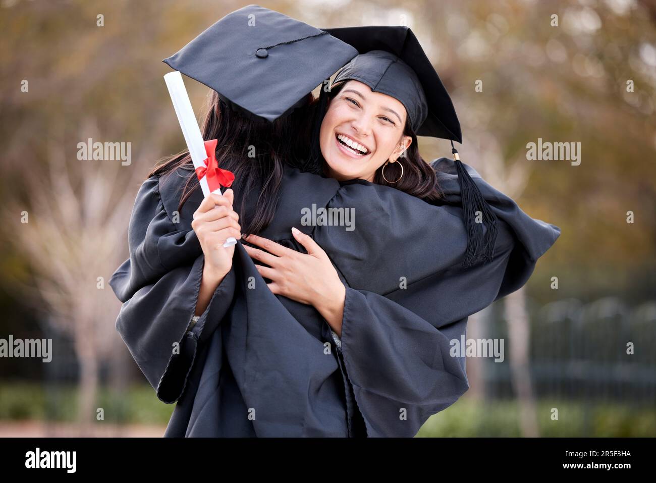 Woman friends, congratulations hug and graduation at college, campus ...