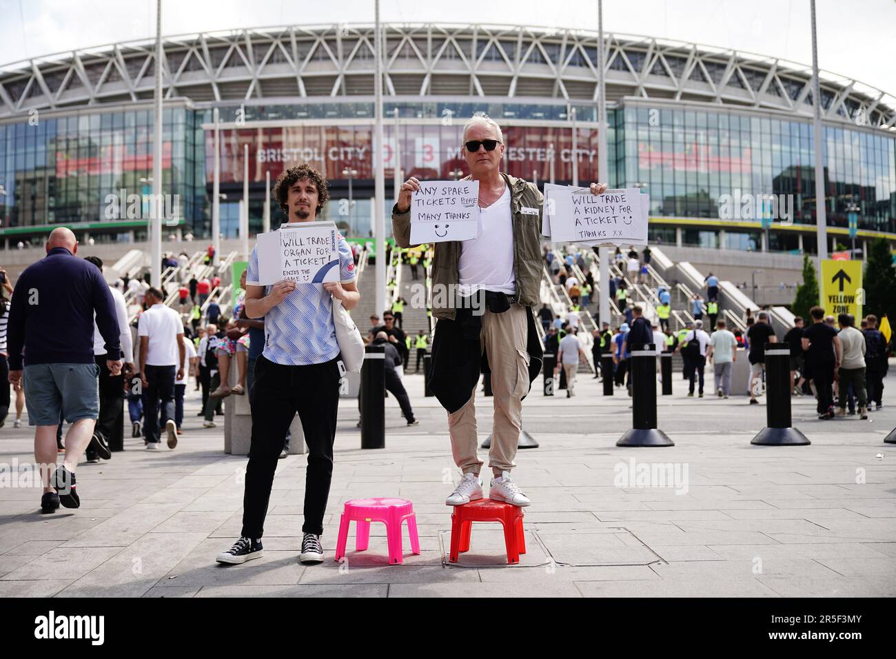 People looking for spare tickets hold up signs outside Wembley Stadium ...