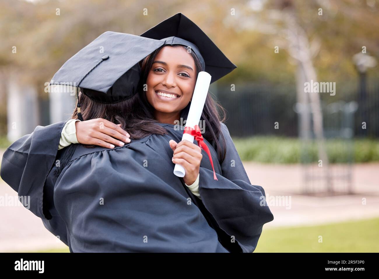 Women friends, hug and graduation portrait at college, campus and ...