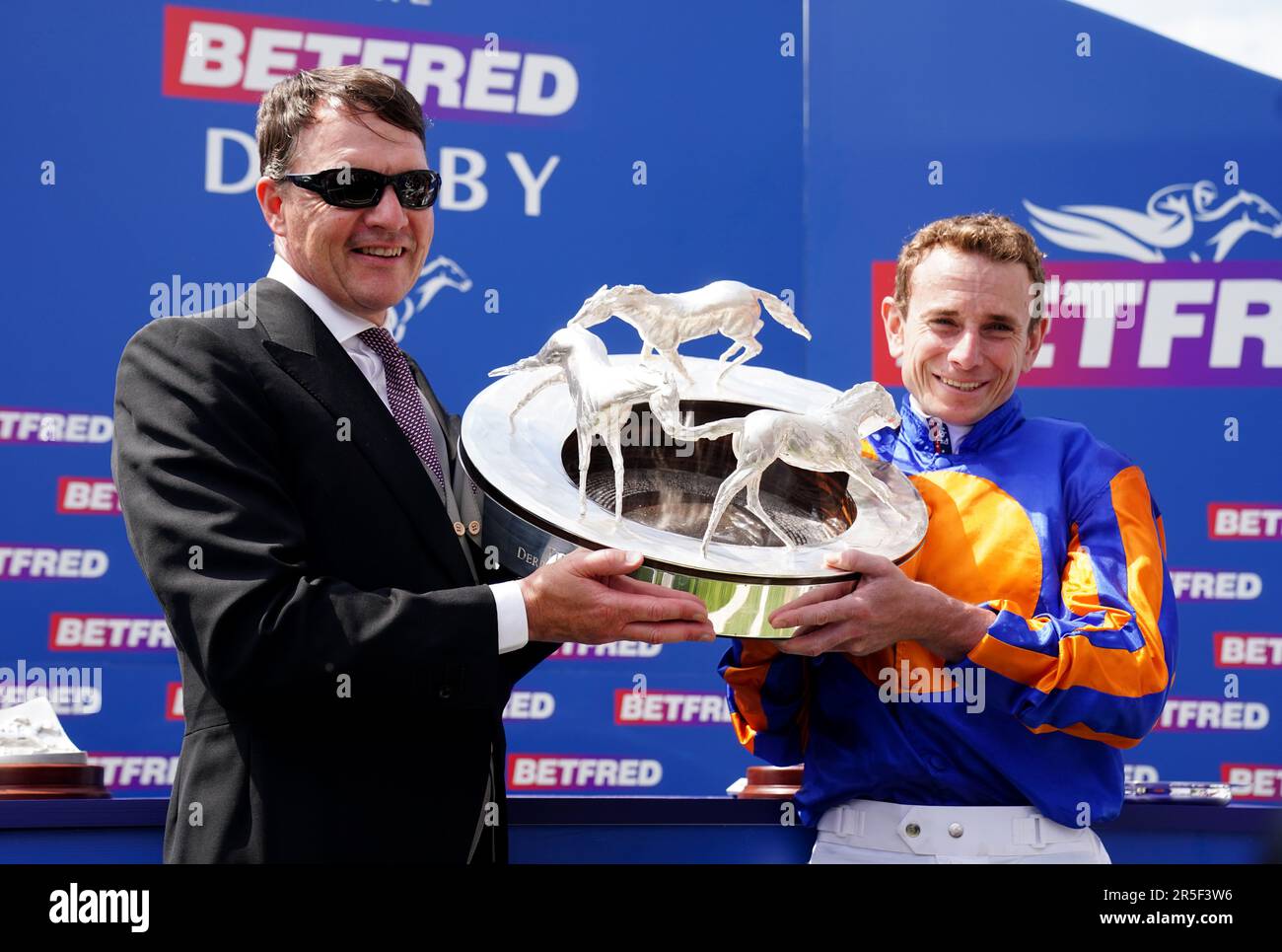 Ryan Moore (right) and trainer Aidan O'Brien pose with The Derby Trophy ...