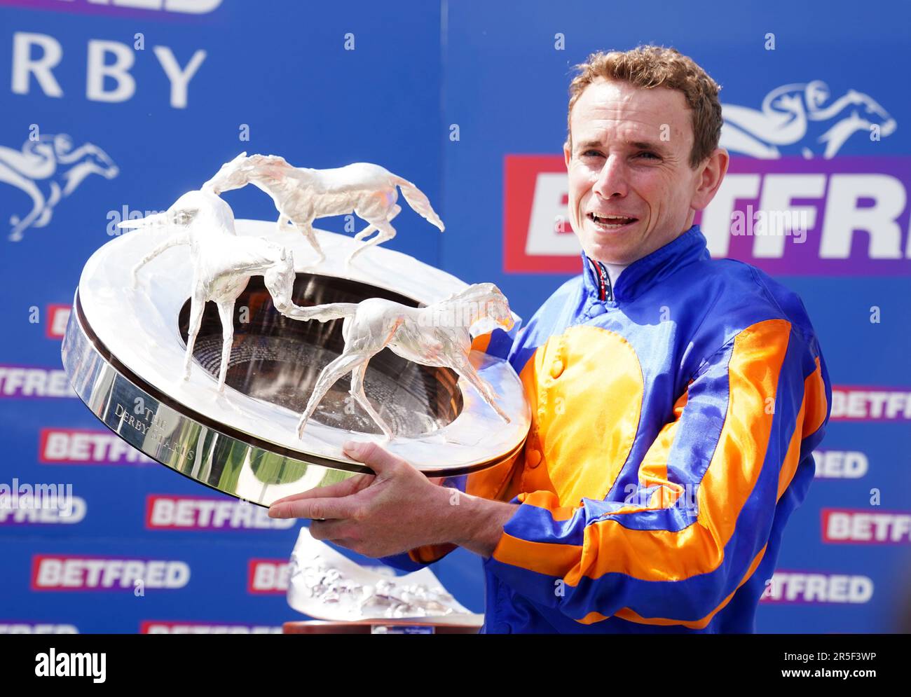 Ryan Moore poses with The Derby Trophy during Derby Day of the 2023 ...