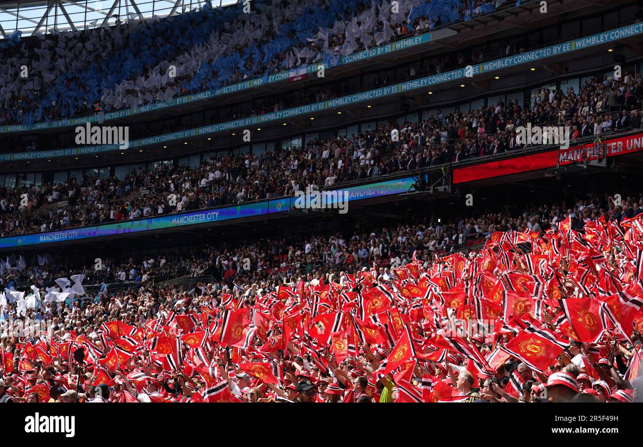 Manchester United fans wave flags in the stands ahead of the Emirates ...