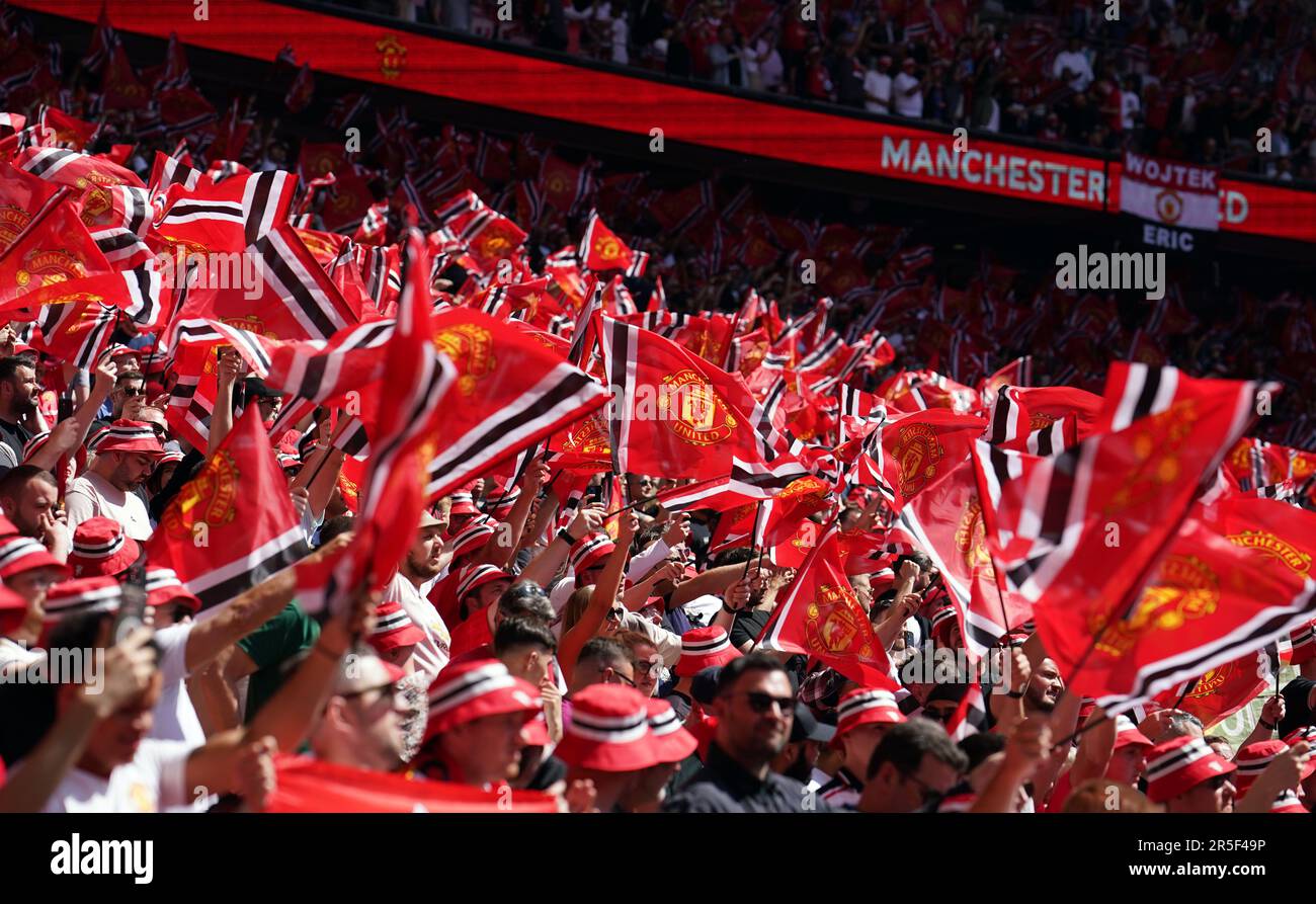 Manchester United fans wave flags in the stands ahead of the Emirates ...