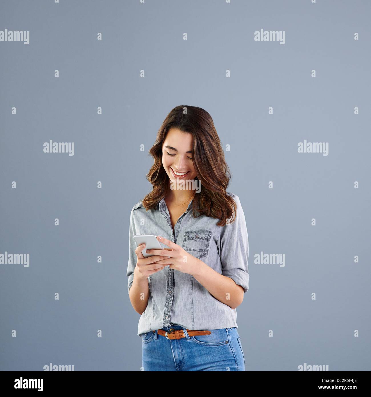 Sending the perfect reply. Studio shot of an attractive young woman ...