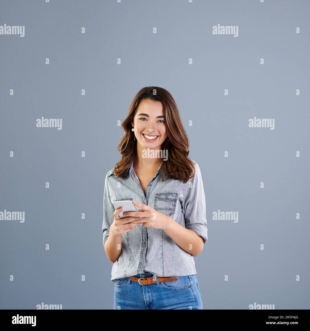 Some texts are just made to make you smile. Studio portrait of an attractive young woman sending ...