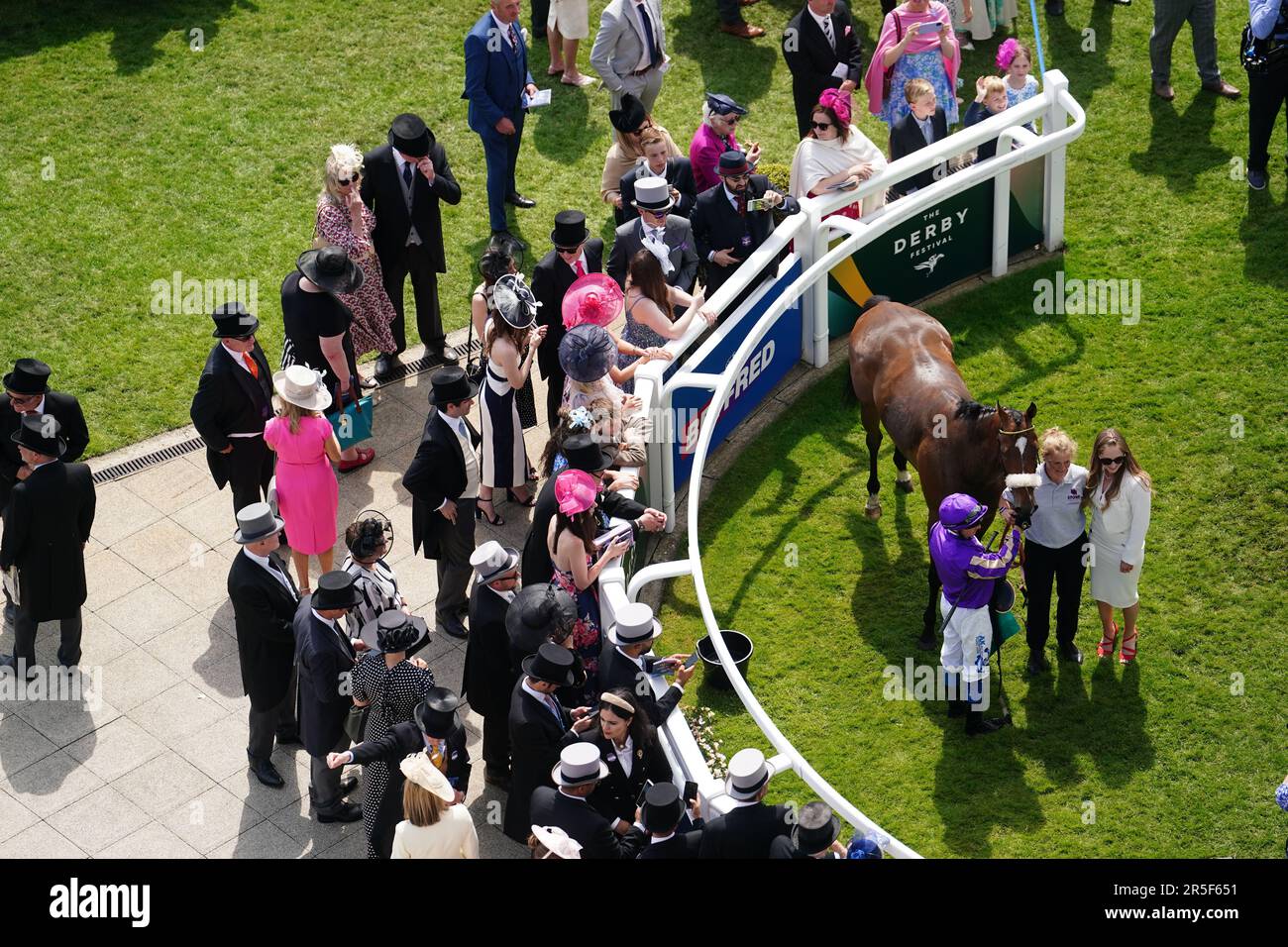 Race goers look on as Tatterstall and jockey Connor Beasley pose for a ...
