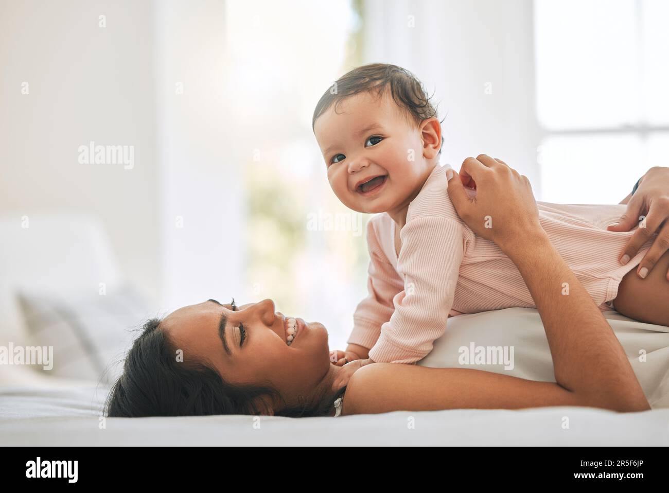 Mom lying, cuddle newborn and bedroom with smile, care and happiness in ...