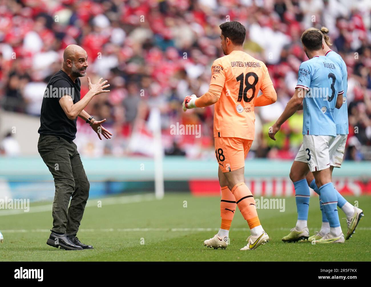 Manchester City manager Pep Guardiola (left) speaks to goalkeeper ...