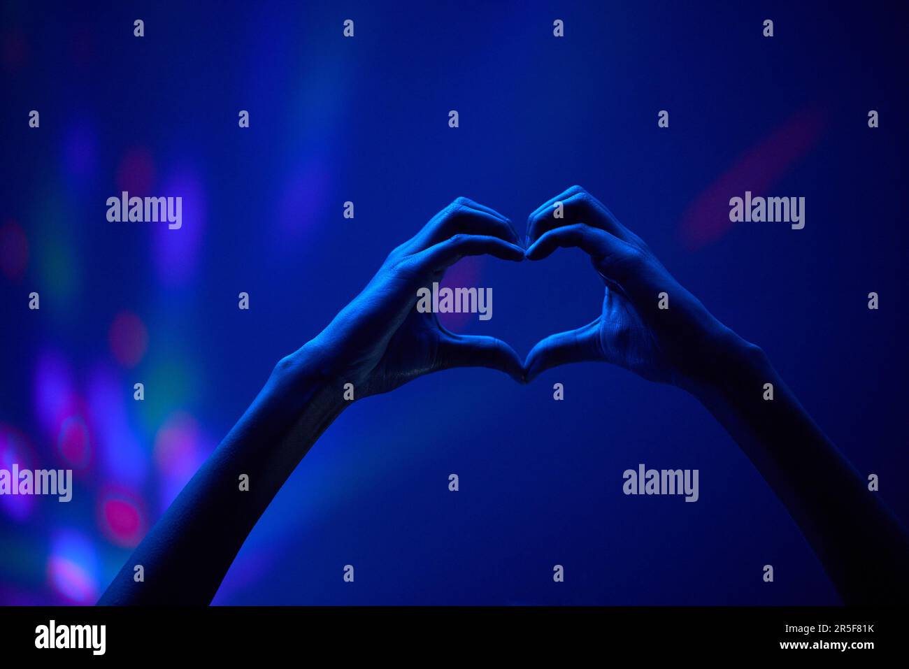 Lights, heart hands of fan at party or concert at night, stadium ...