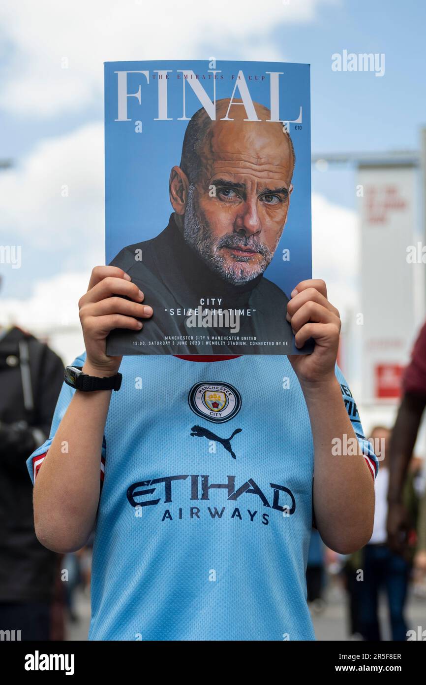 London, UK. 3 June 2023. A Manchester City fan holds the official ...