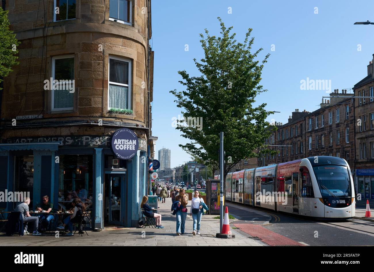 Edinburgh Scotland, UK 03 June 2023. People sit outside a cafe on Leith Walk by the Edinburgh ...