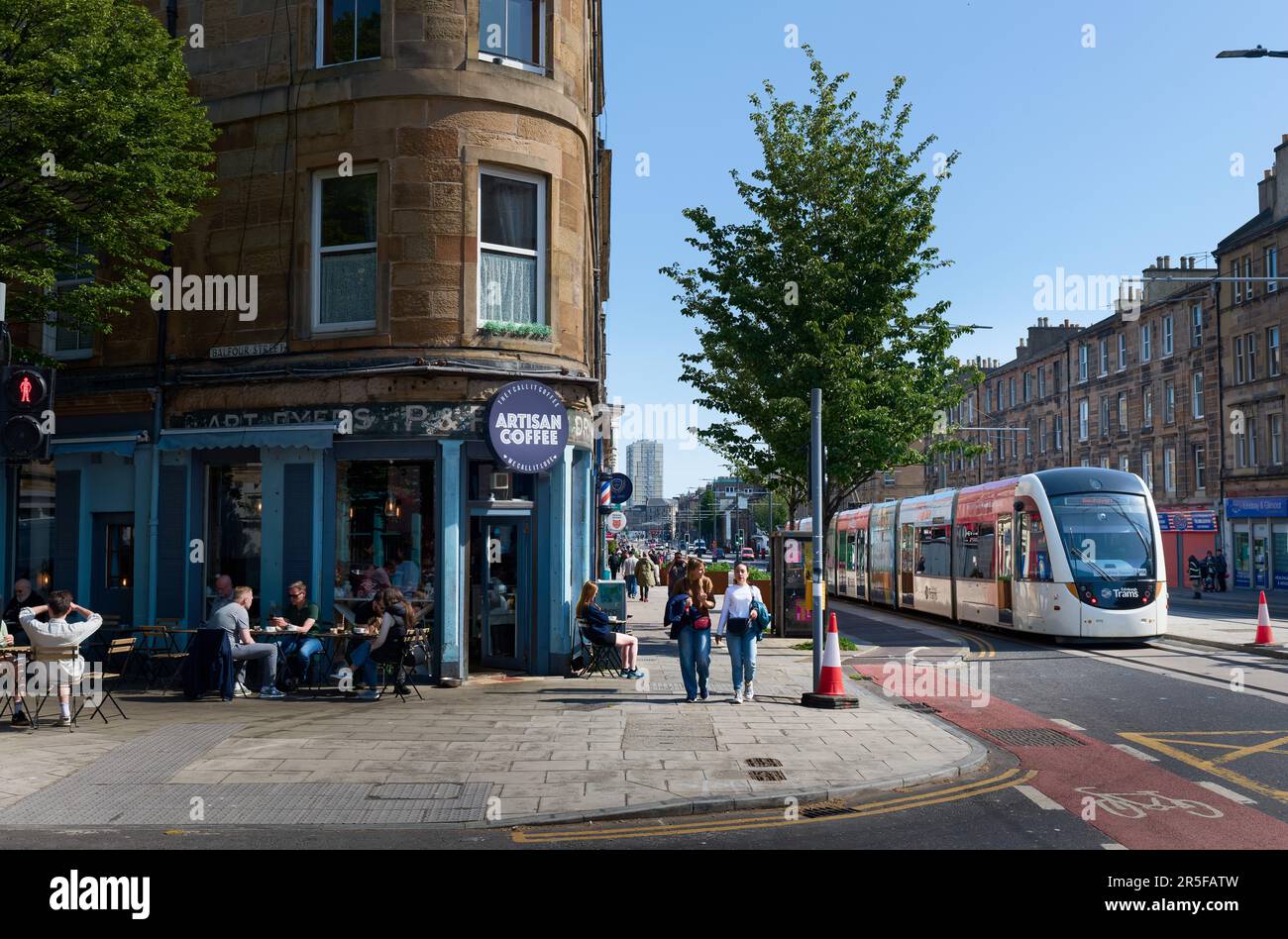 Edinburgh Scotland, UK 03 June 2023. People sit outside a cafe on Leith Walk by the Edinburgh ...