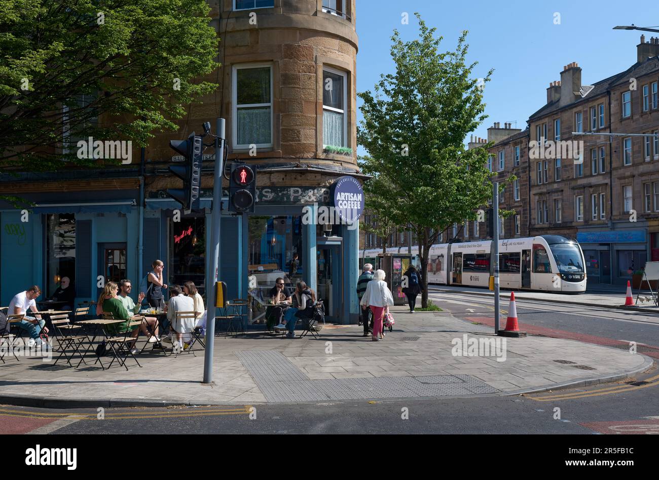 Edinburgh Scotland, UK 03 June 2023. People sit outside a cafe on Leith Walk by the Edinburgh ...