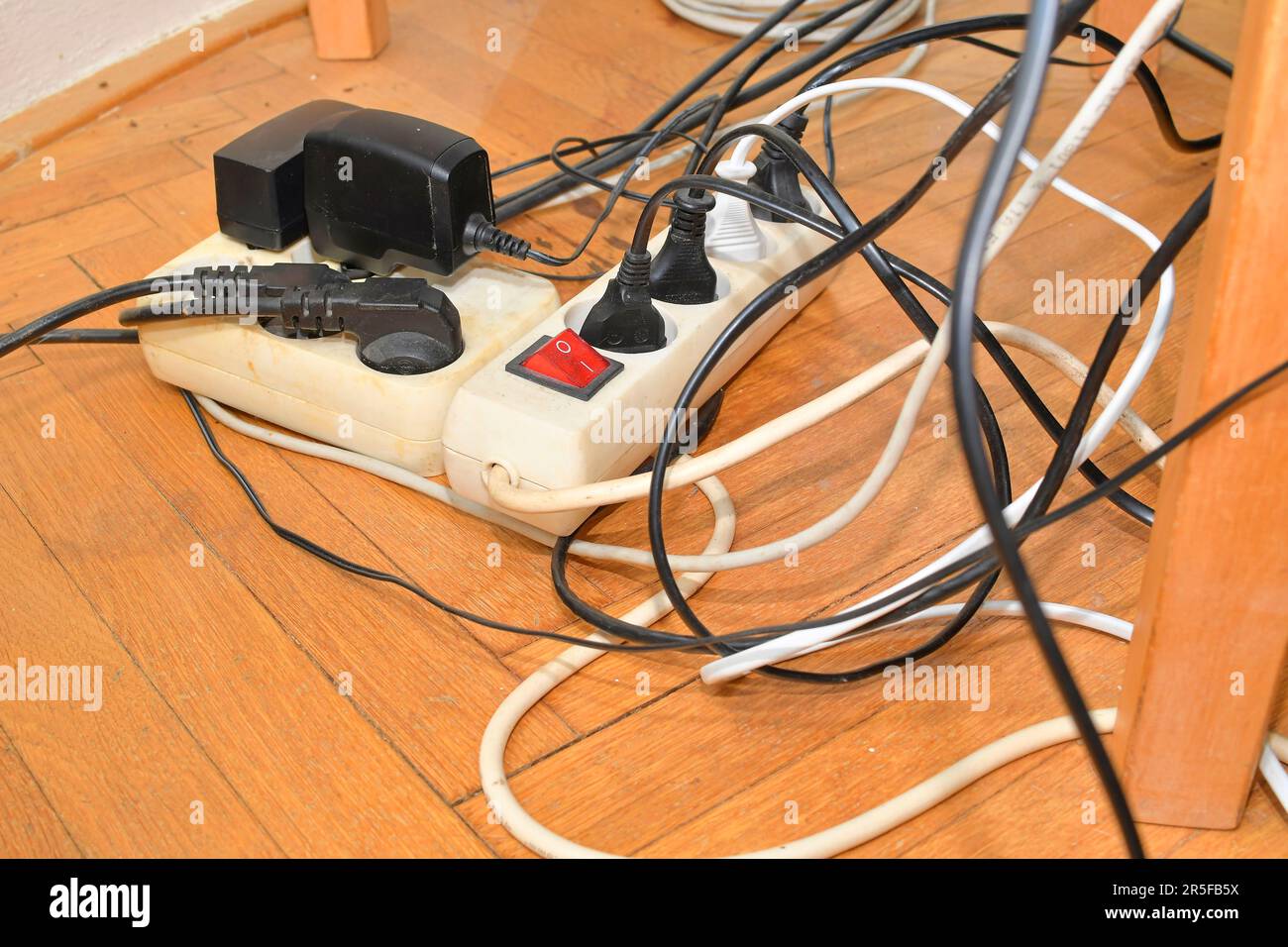 Tangled Cables In The Extension Cord Messy Cables Cables Tangled On Parquet Flooring Stock