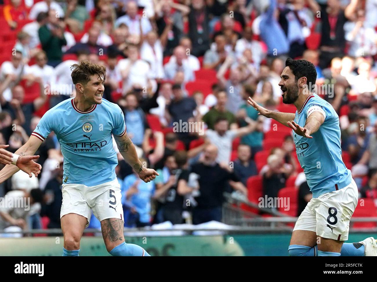 Manchester City's Ilkay Gundogan (right) celebrates scoring their side ...