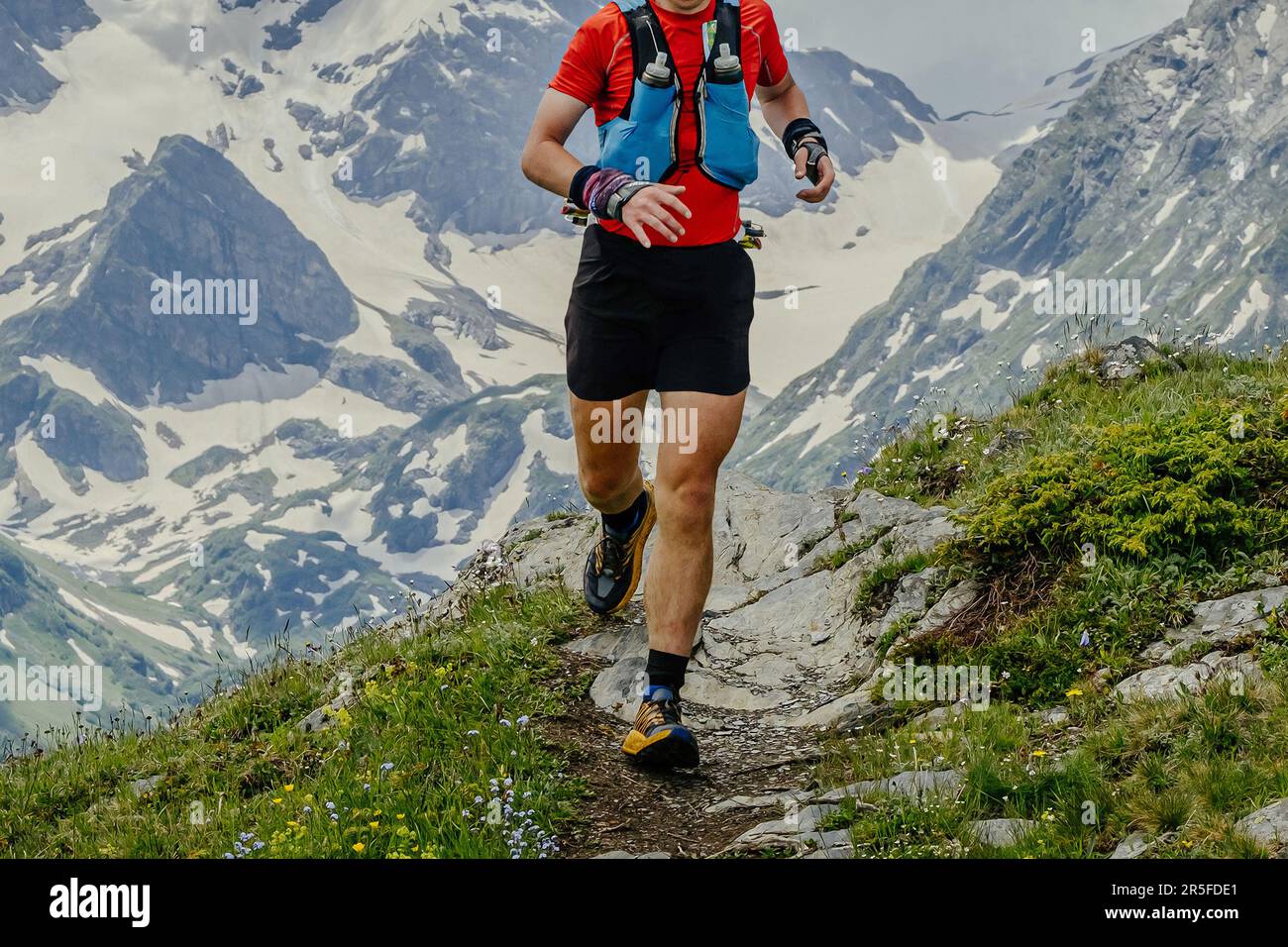 athlete runner running mountain trail skyrunning marathon in background ...