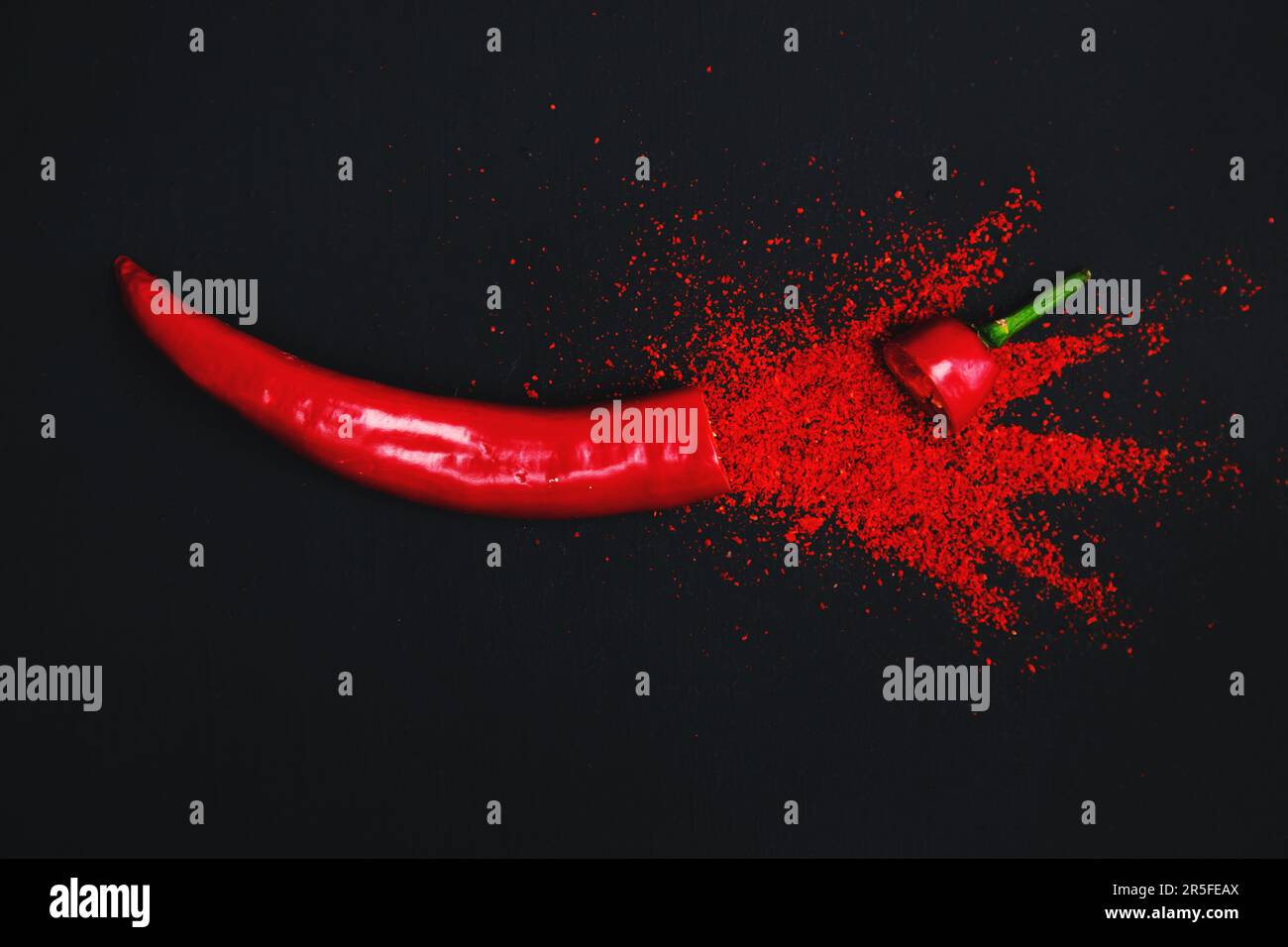 Exploding pepper. Chili pepper turns into powder. Dark background Stock ...