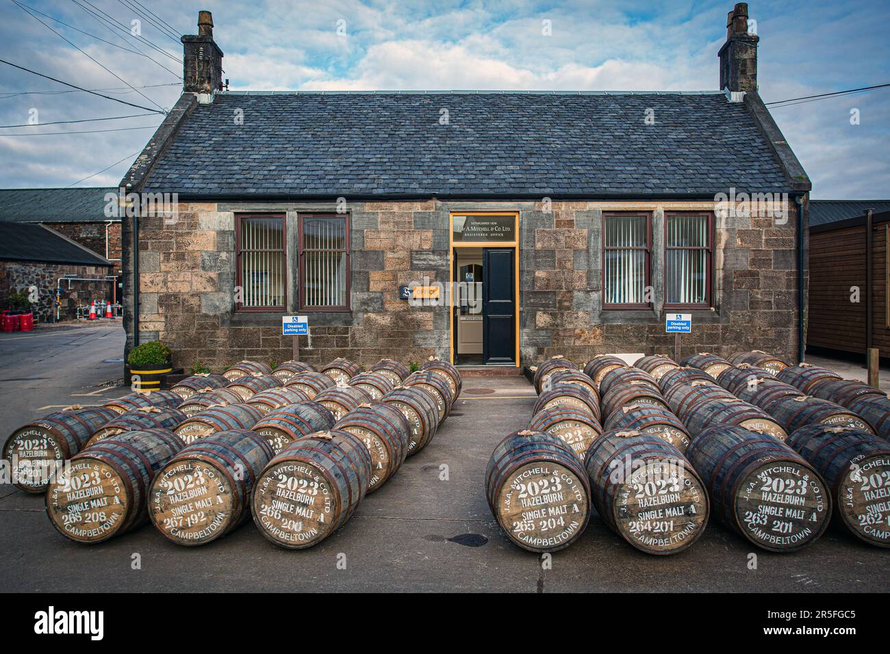 Exterior of Springbank Distillery with whisky barrels , Campbeltown ...
