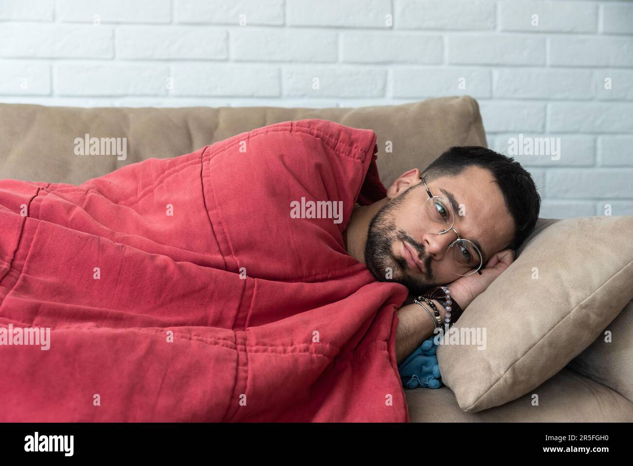 Absolute solitude. Side view of a depressed unhappy sad man lying on ...