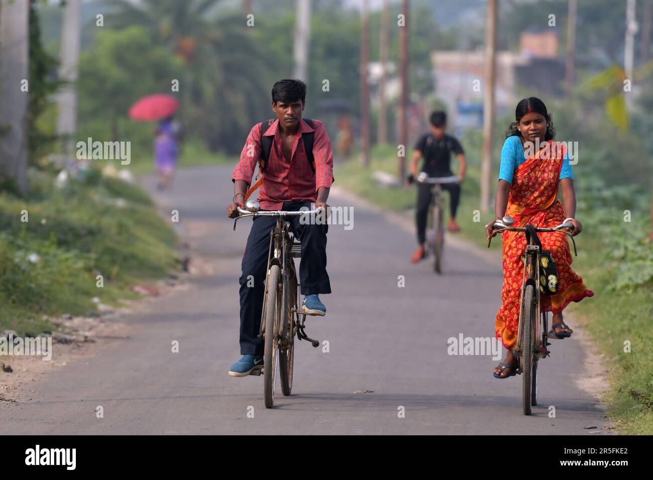 Villagers riding bicycles on World Bicycle Day in the Newtown area of ...
