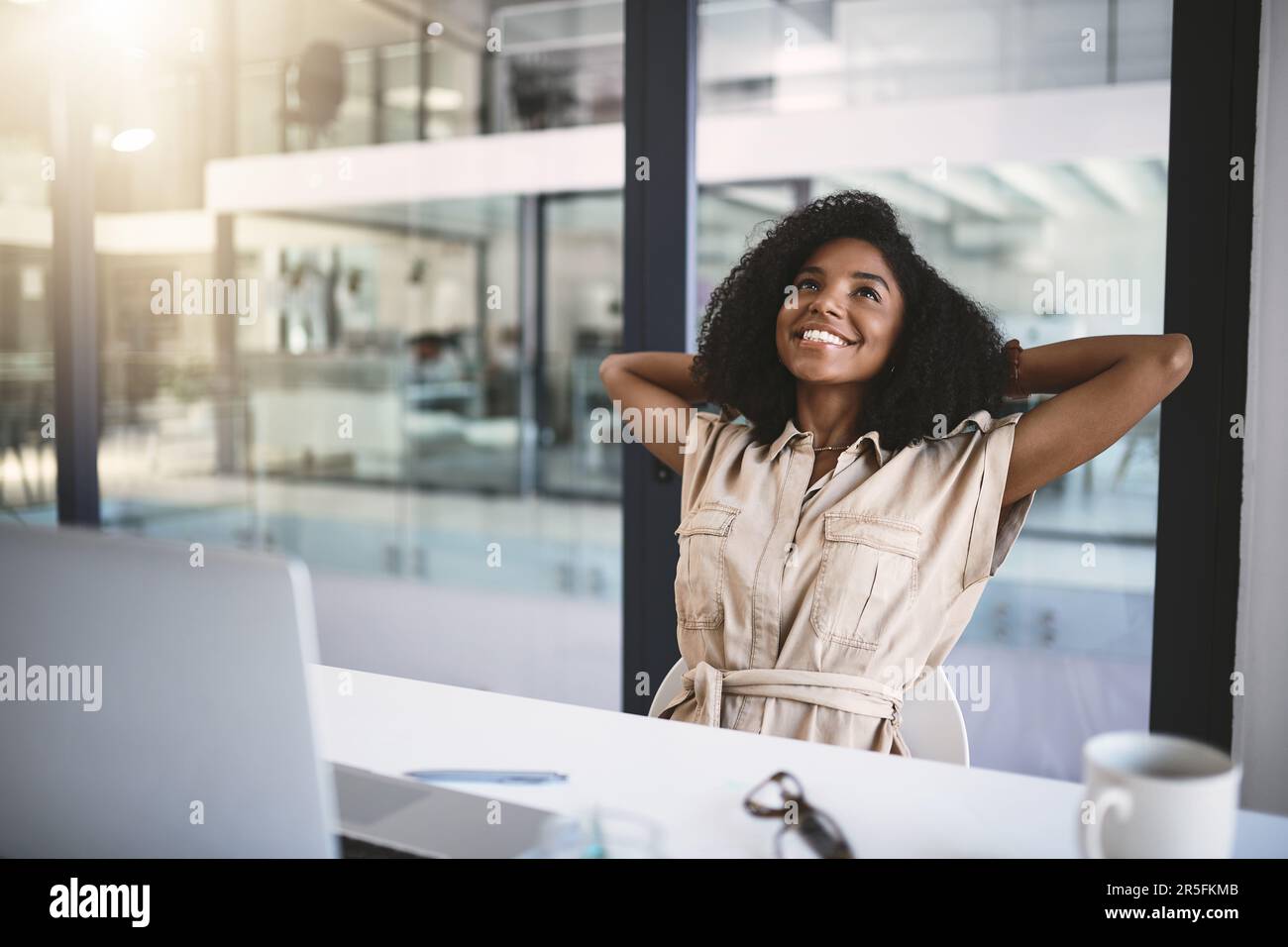 When work feels like a vacation. a happy young businesswoman relaxing ...
