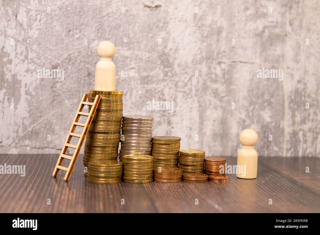 Side view of businessman with a suitcase climbing giant coin stacks ...