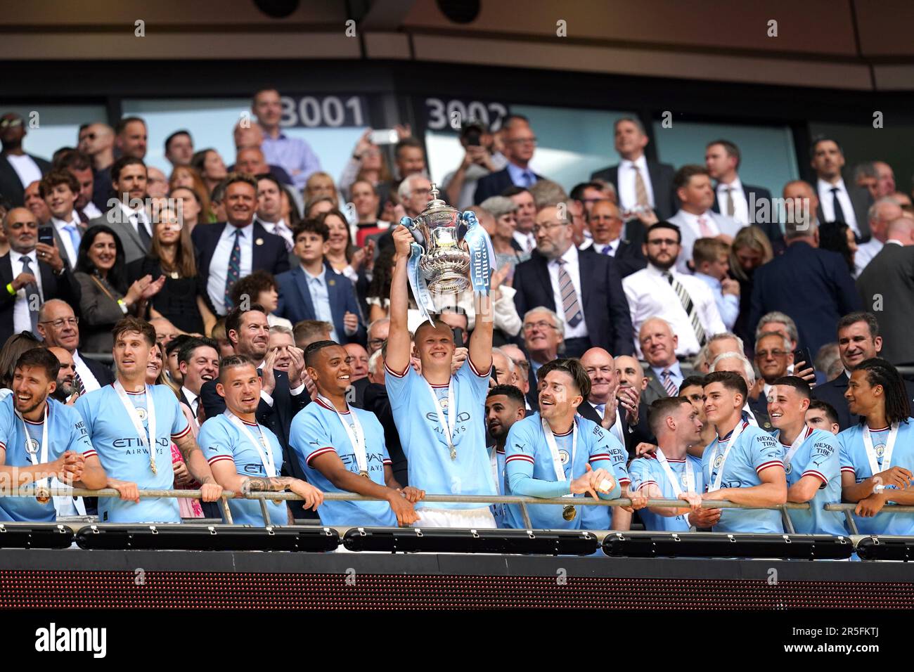 Manchester City's Erling Haaland (centre) lifts the Emirates FA Cup ...
