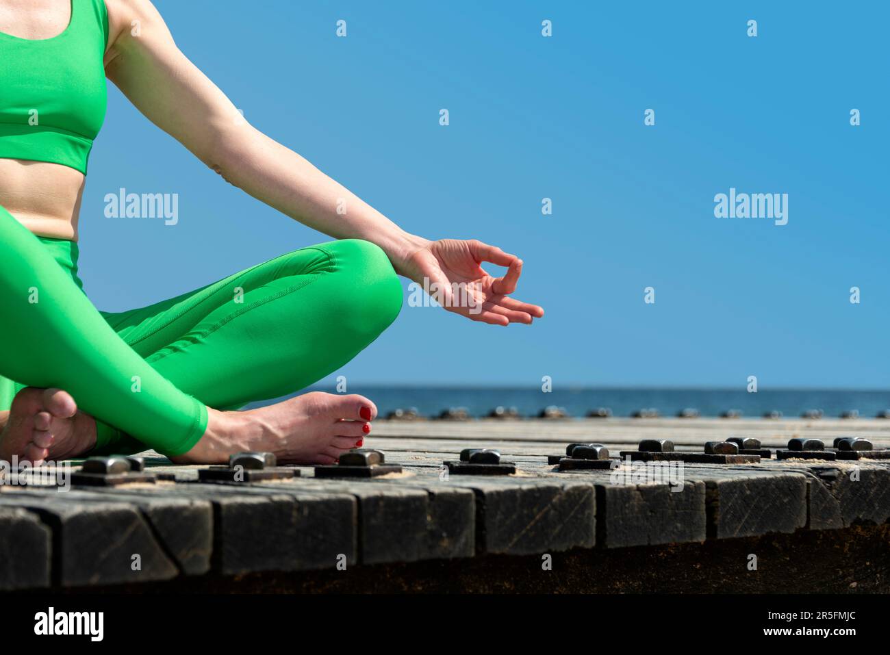Close up of woman practicing yoga meditation exercise outside in the ...