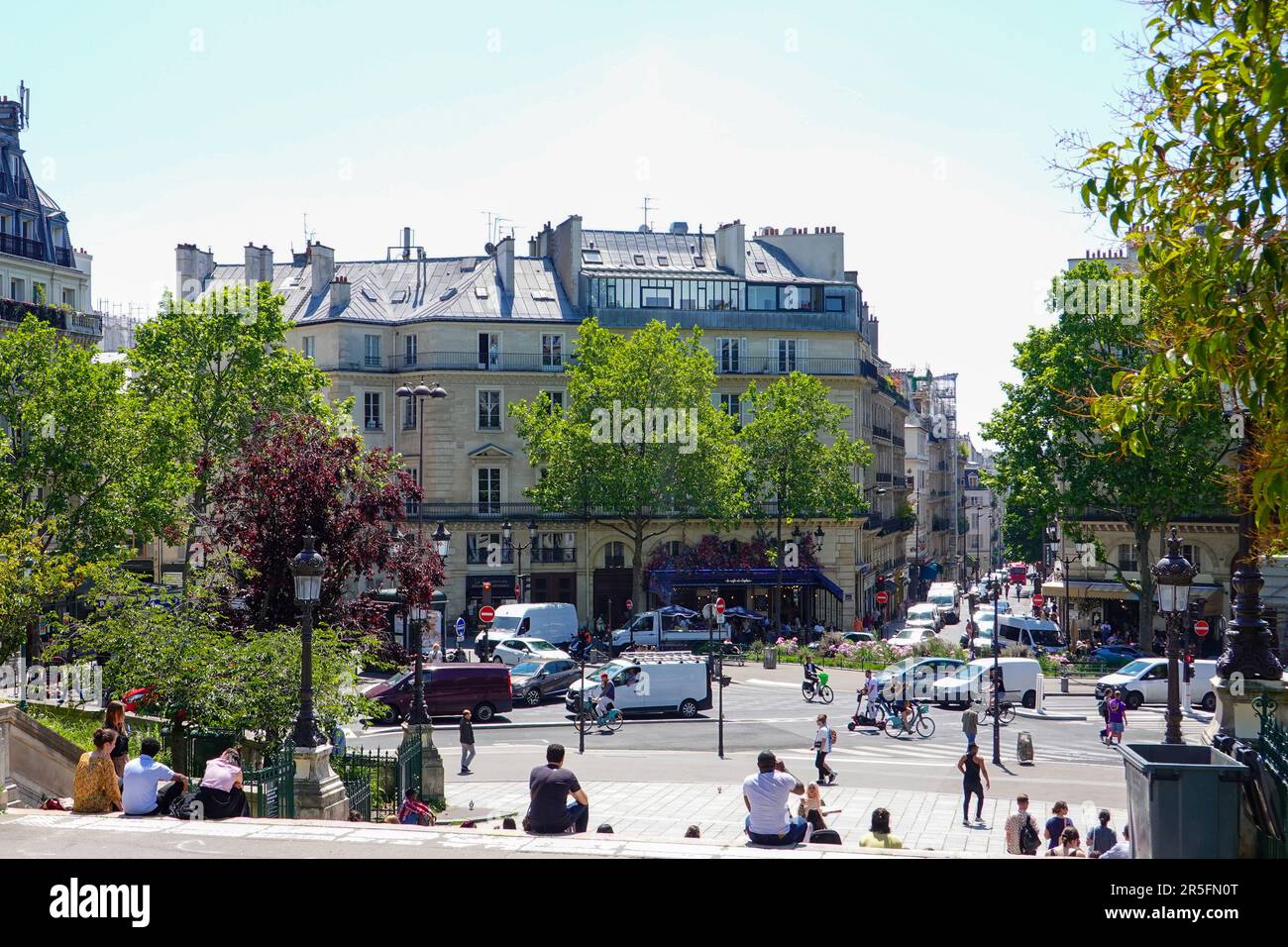 People sitting on the steps of Saint Vincent de Paul Catholic Church ...