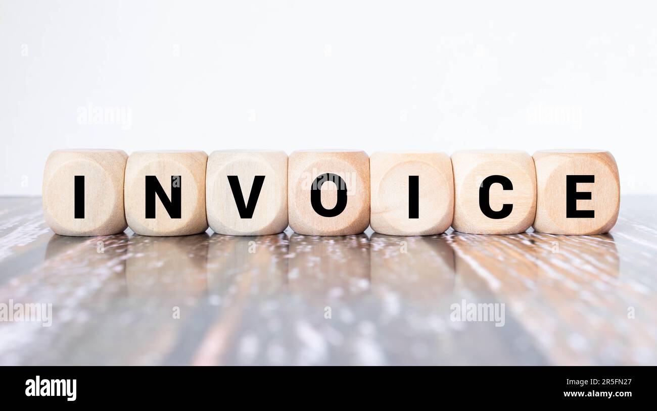 INVOICES word written on wood block. INVOICES text on wooden table for ...
