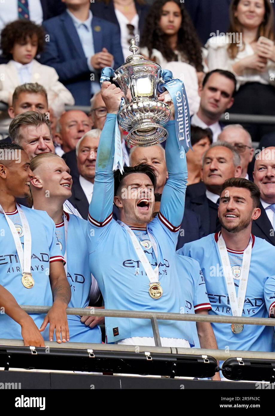 Manchester City's Jack Grealish lifts the Emirates FA Cup trophy ...
