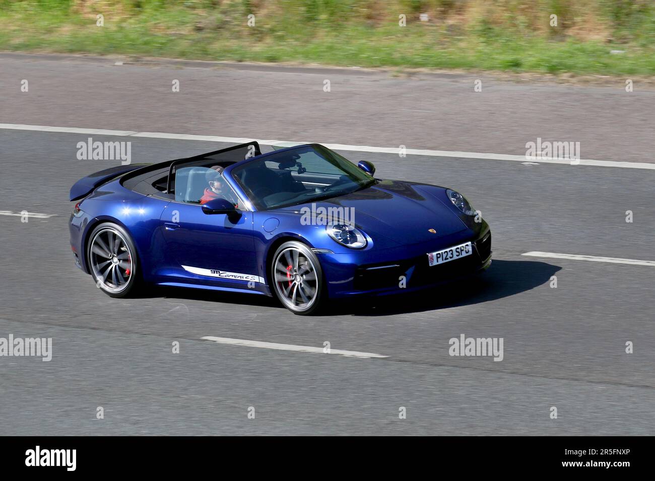 2021 Gentian Blue metallic Porsche 911 Carrera 4S cabrio, travelling on ...