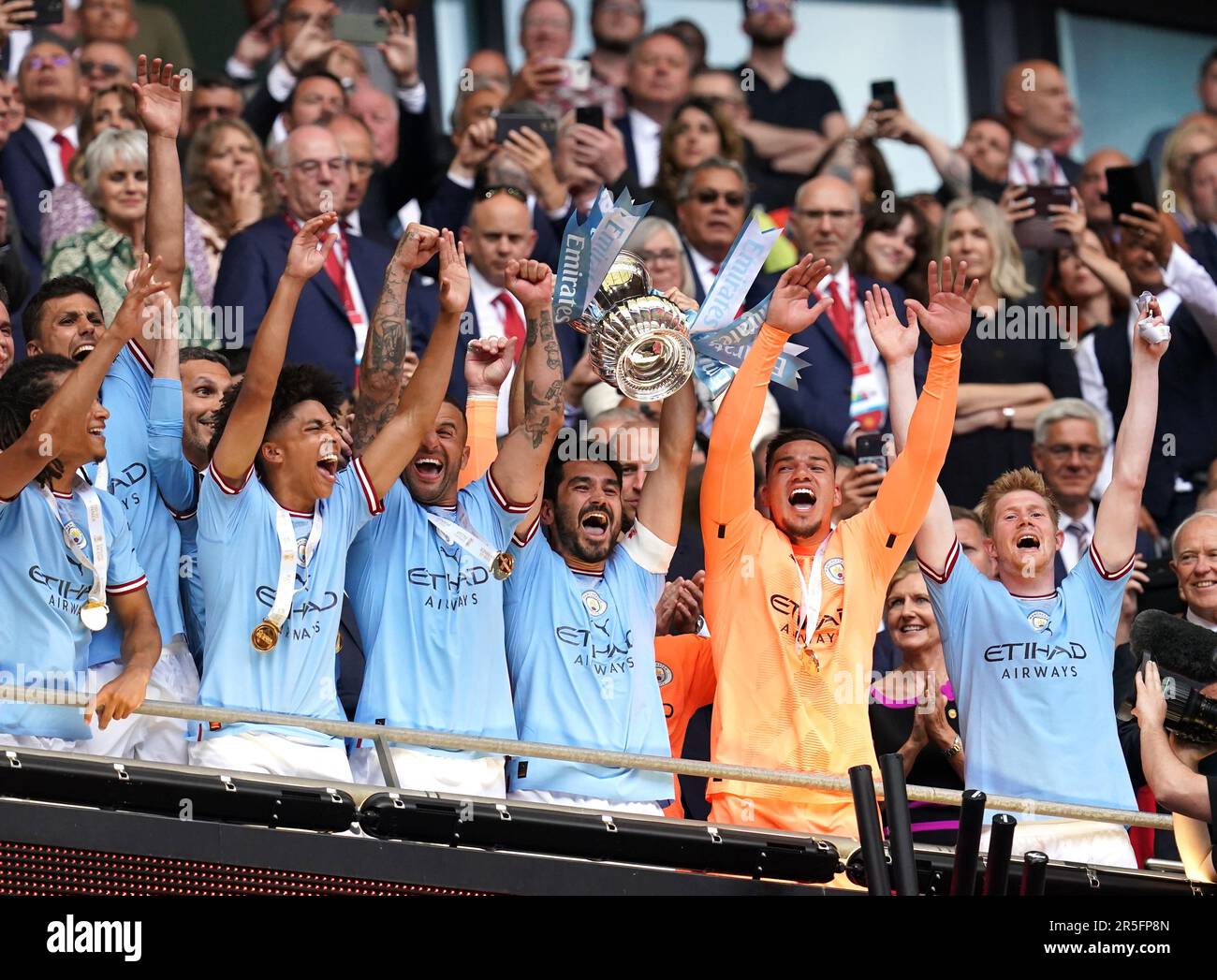 Manchester City's Ilkay Gundogan lifts the Emirates FA Cup trophy ...