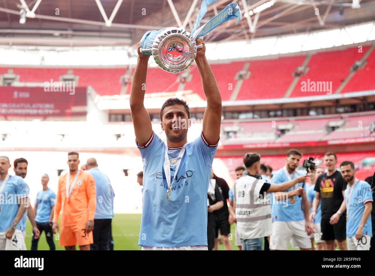 Manchester City's Rodri with the Emirates FA Cup trophy following the ...
