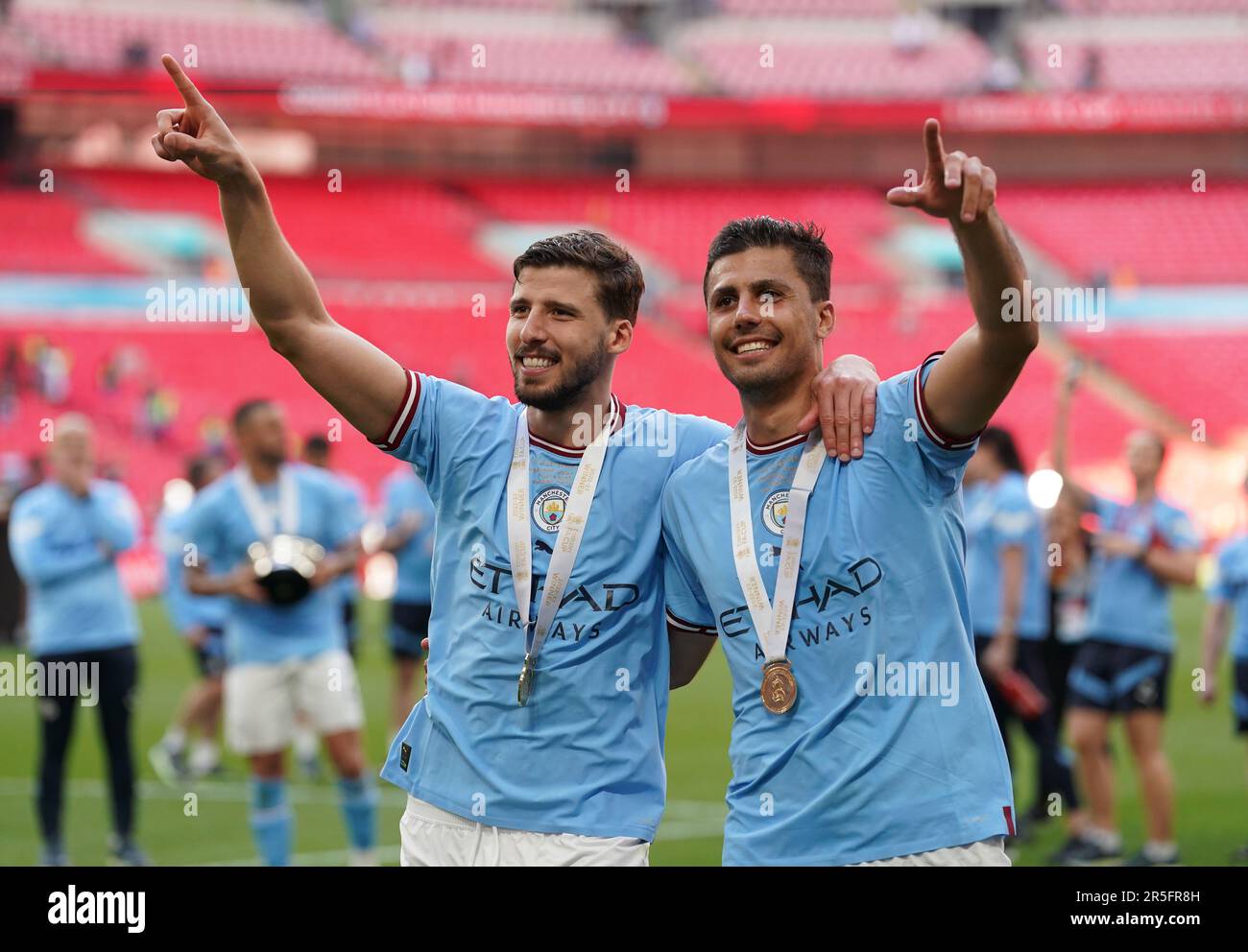 Manchester City's Ruben Dias (left) and Rodri celebrate on the pitch ...