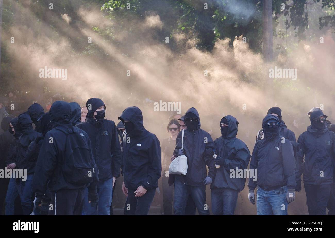 Leipzig, Germany. 03rd June, 2023. Hooded demonstrators stand in clouds ...