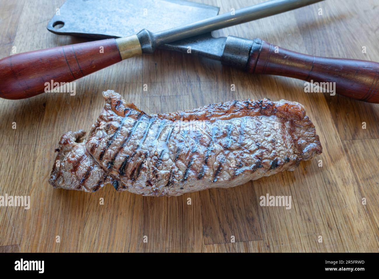Rustic meat chopper accentuates the presentation of a grilled sirloin ...