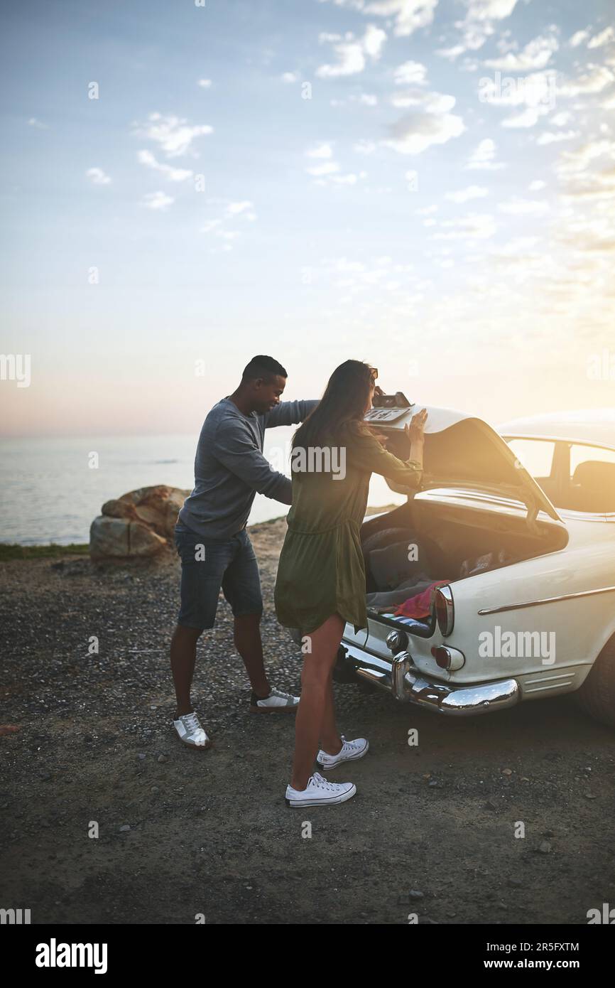 Lets get our blanket and watch the sunset. a young couple making a stop ...