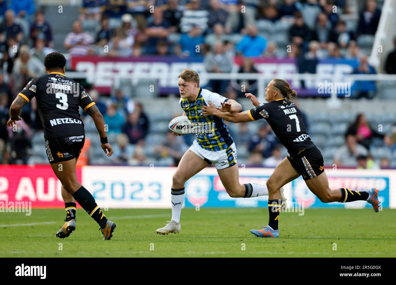 Leeds Rhinos' James McDonnell (centre) is tackled by Castleford Tigers ...
