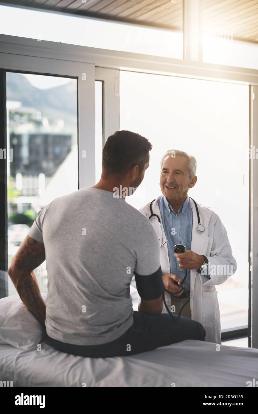 Im giving you the all clear. a senior doctor giving his male patient a ...