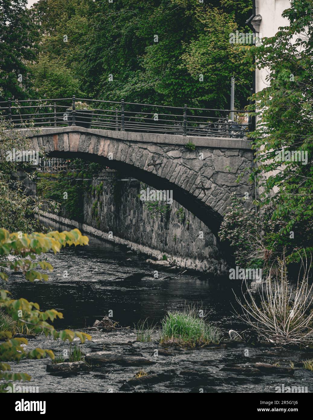 View of old stone bridge over a stream Stock Photo - Alamy